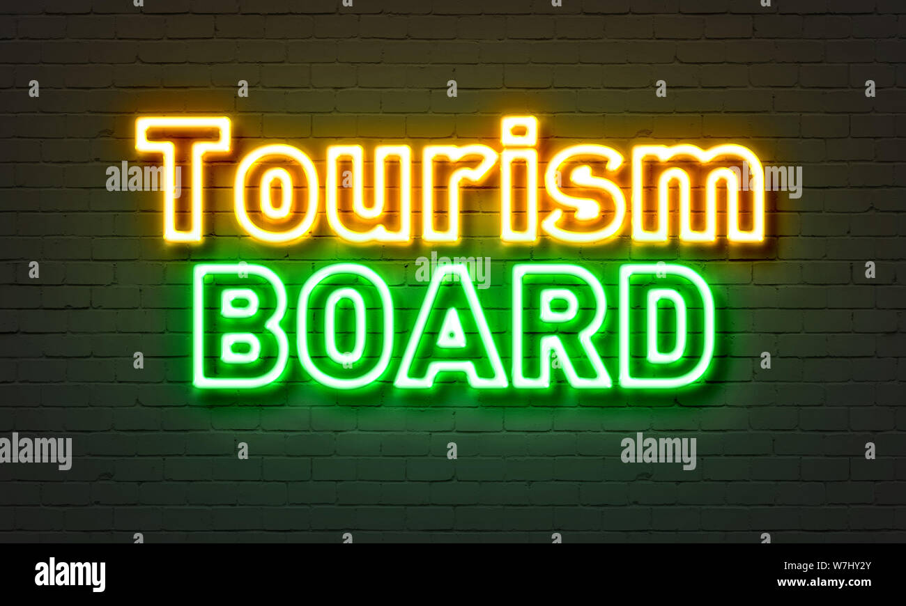 Tourism board neon sign on brick wall background Stock Photo - Alamy