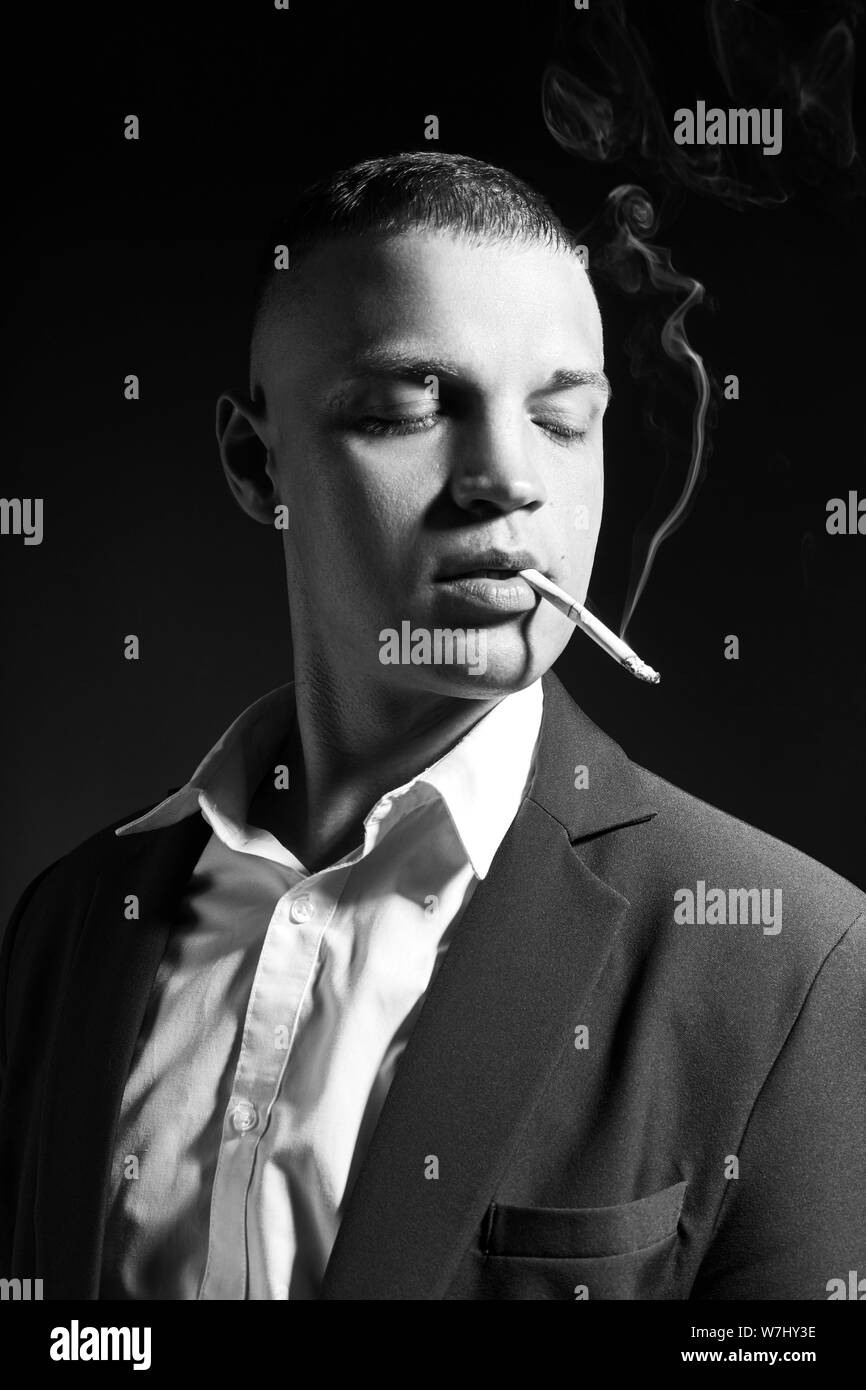 Fashion model smoking cigarette Black and White Stock Photos & Images ...