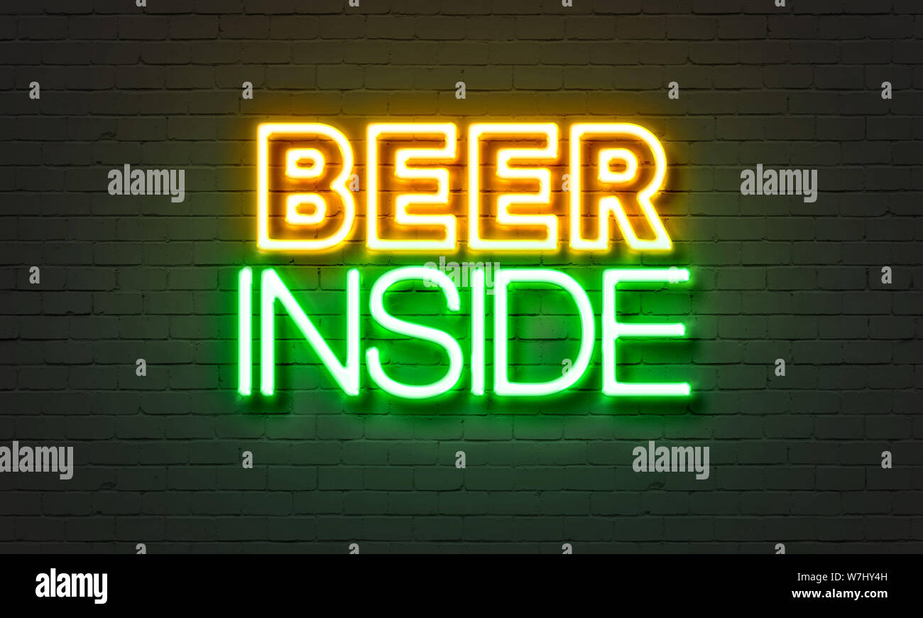 Beer inside neon sign on brick wall background Stock Photo - Alamy