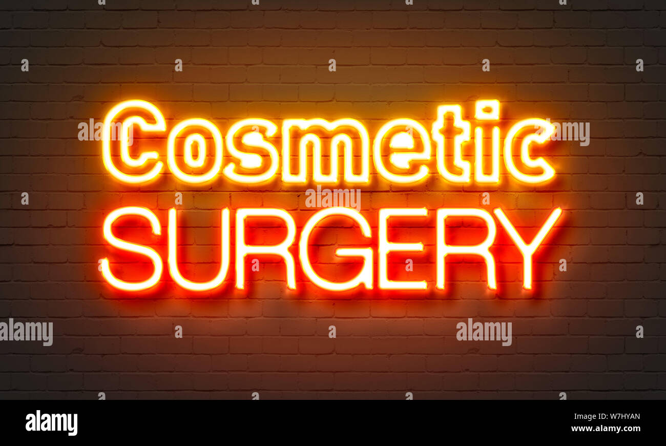 Cosmetic surgery neon sign on brick wall background Stock Photo - Alamy