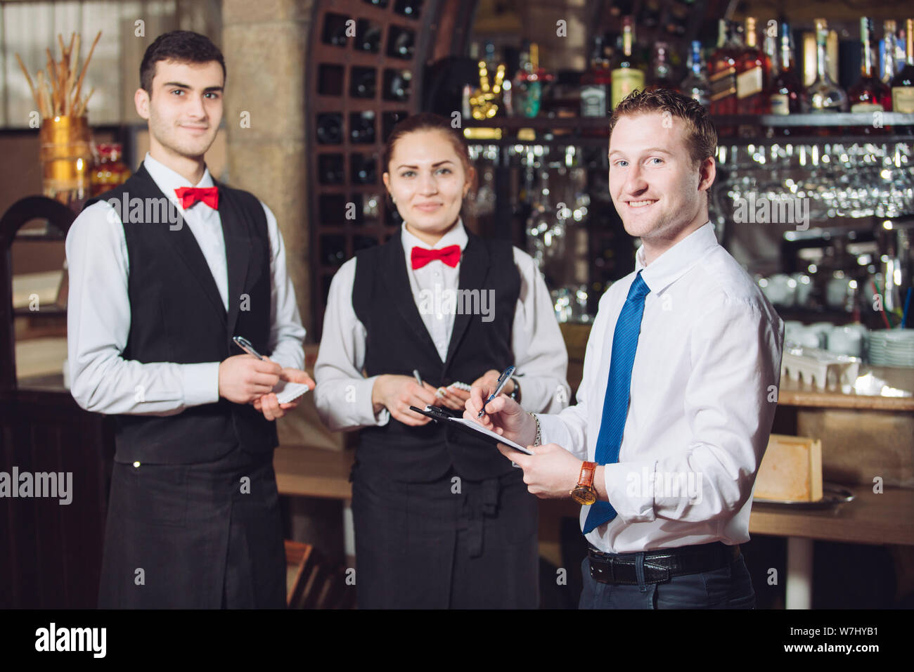 Manager's briefing with the waiters. Restaurant manager and his staff ...