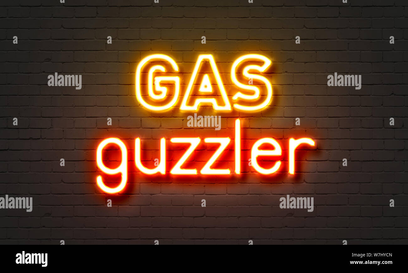 Gas guzzler neon sign on brick wall background Stock Photo - Alamy