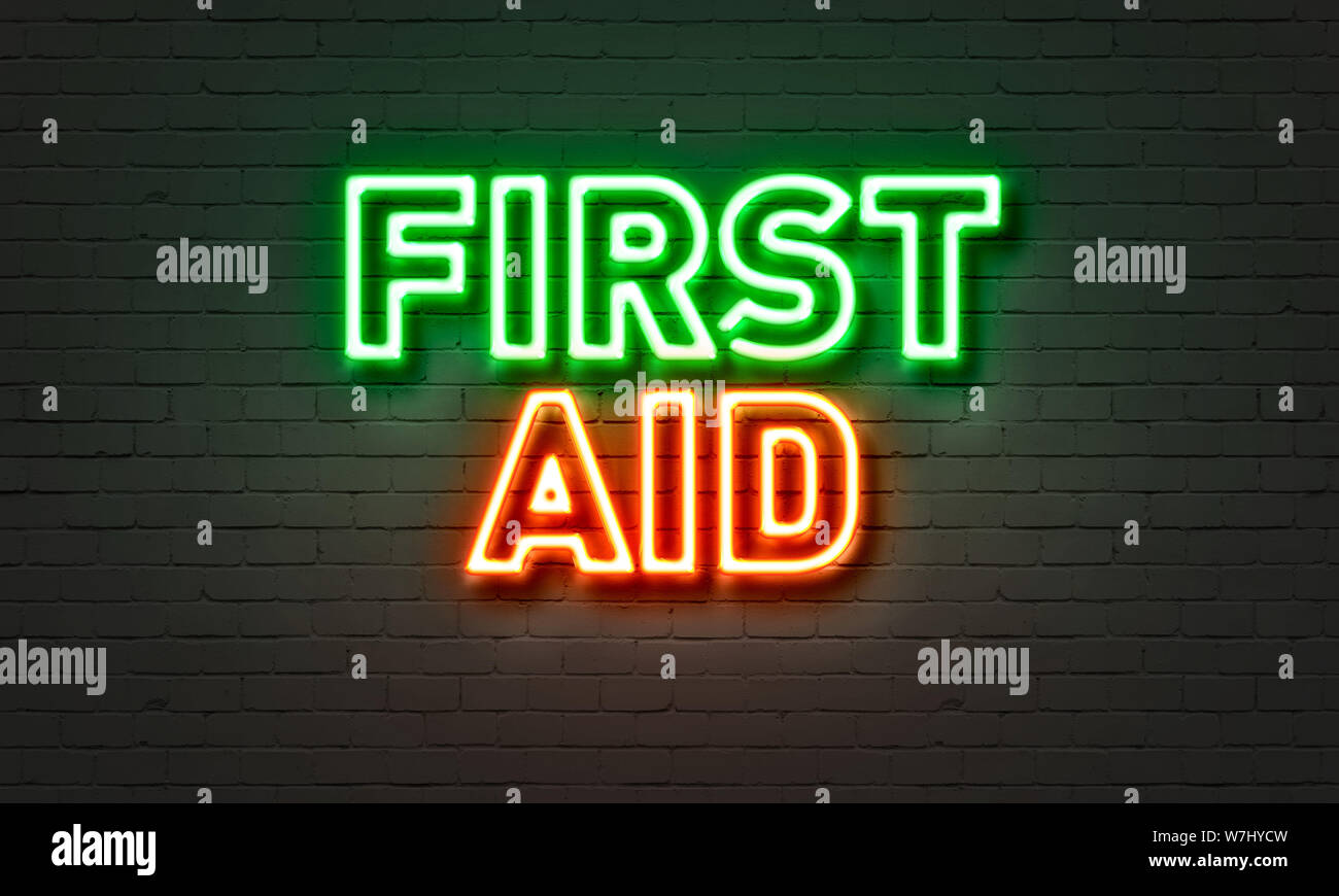 First aid neon sign on brick wall background Stock Photo - Alamy