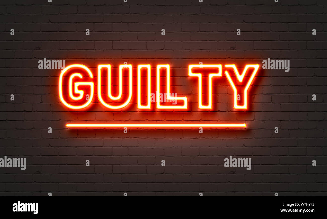 Guilty neon sign on brick wall background Stock Photo - Alamy
