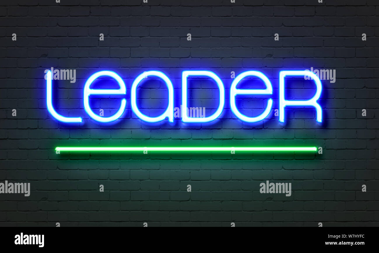 Leader neon sign on brick wall background Stock Photo - Alamy