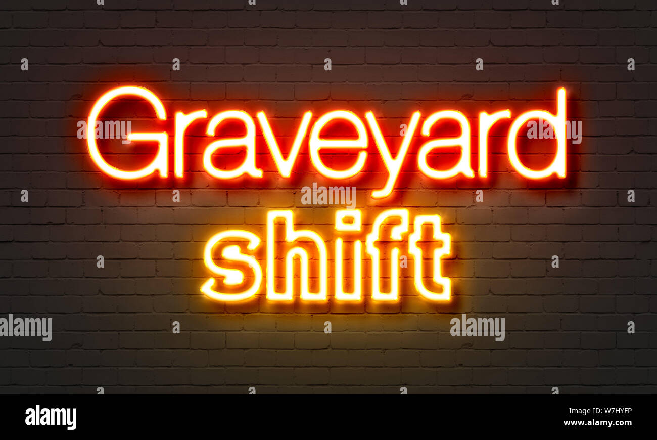 Graveyard shift neon sign on brick wall background Stock Photo - Alamy