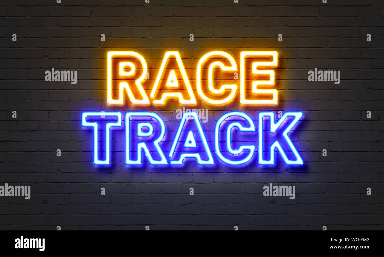 Race track neon sign on brick wall background Stock Photo - Alamy