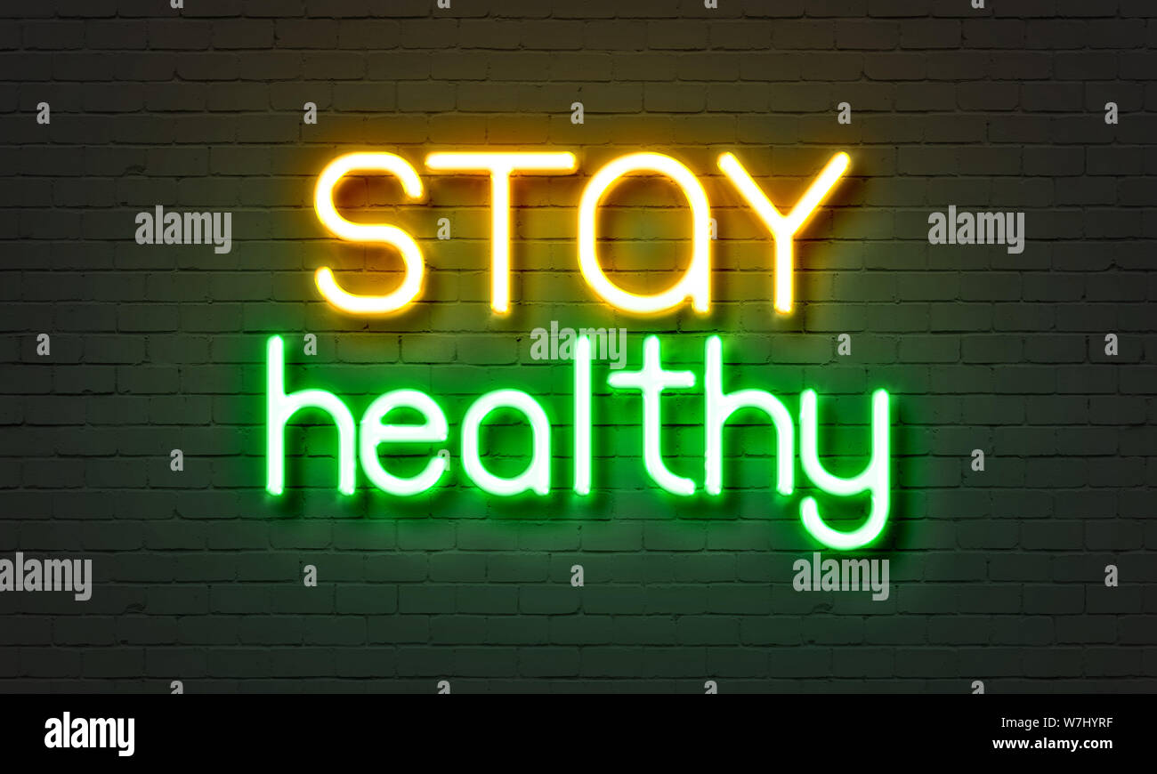 Stay healthy neon sign on brick wall background Stock Photo - Alamy