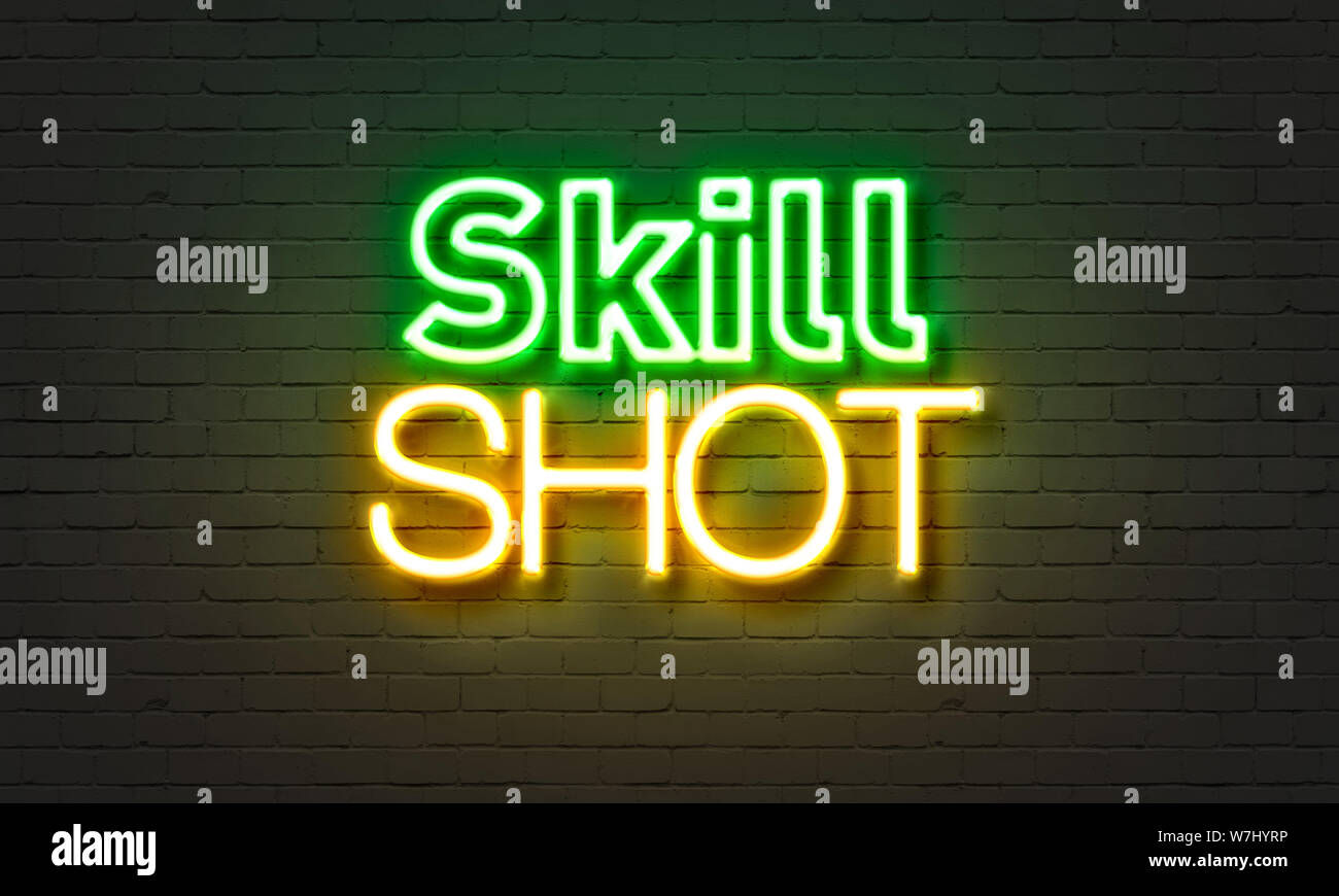 Skill shot neon sign on brick wall background Stock Photo - Alamy