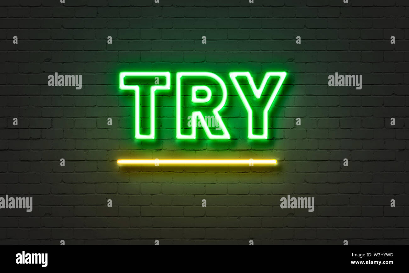 Try neon sign on brick wall background Stock Photo - Alamy