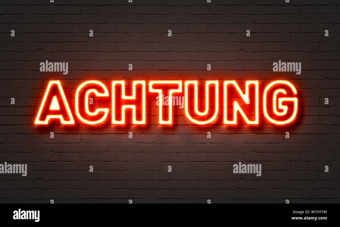 Achtung neon sign on brick wall background Stock Photo - Alamy