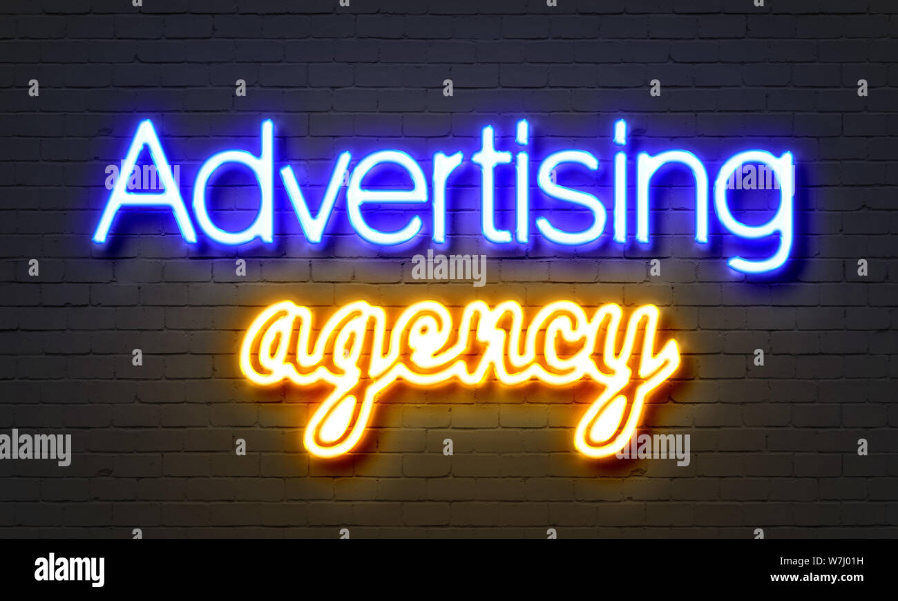Advertising agency neon sign on brick wall background Stock Photo - Alamy