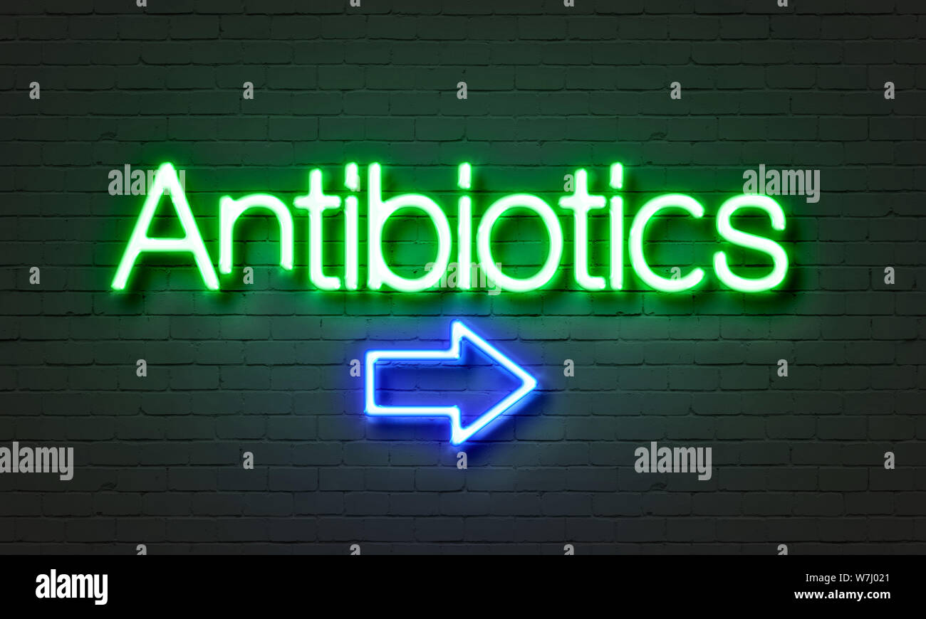 Antibiotics neon sign on brick wall background Stock Photo - Alamy