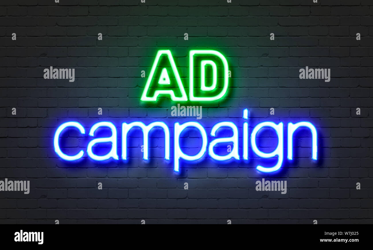 Ad campaign neon sign on brick wall background Stock Photo - Alamy