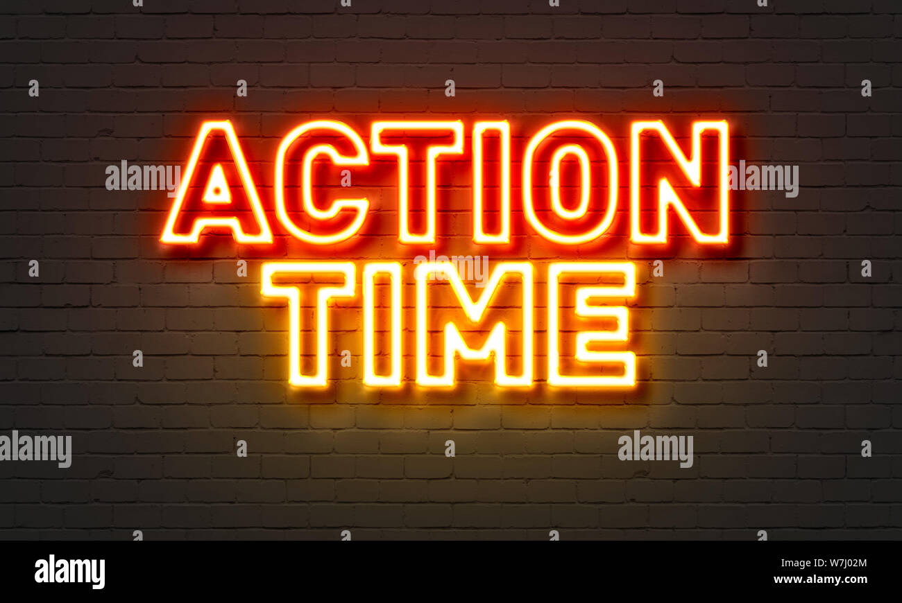 Action time neon sign on brick wall background Stock Photo - Alamy