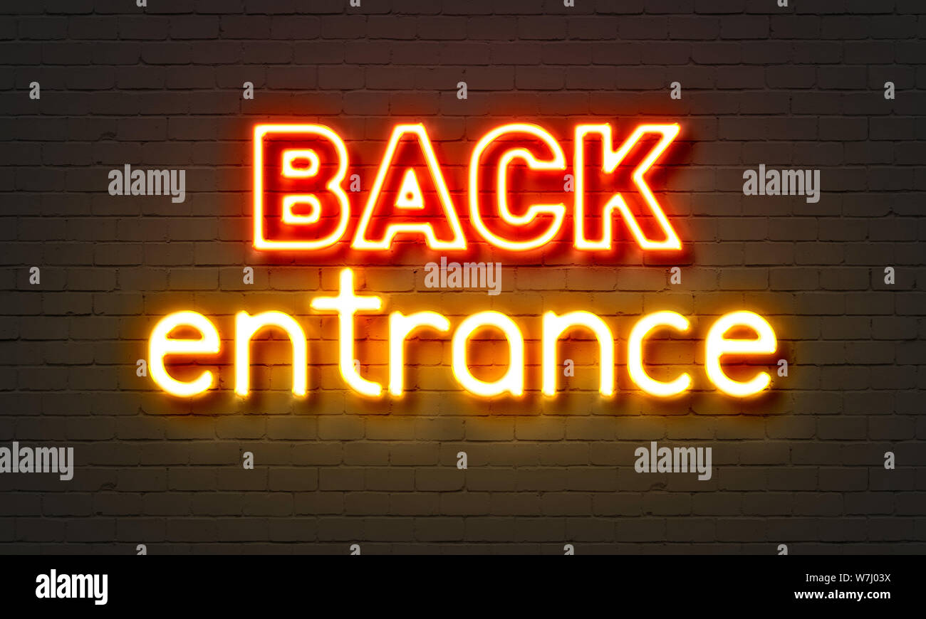 Back entrance neon sign on brick wall background Stock Photo - Alamy