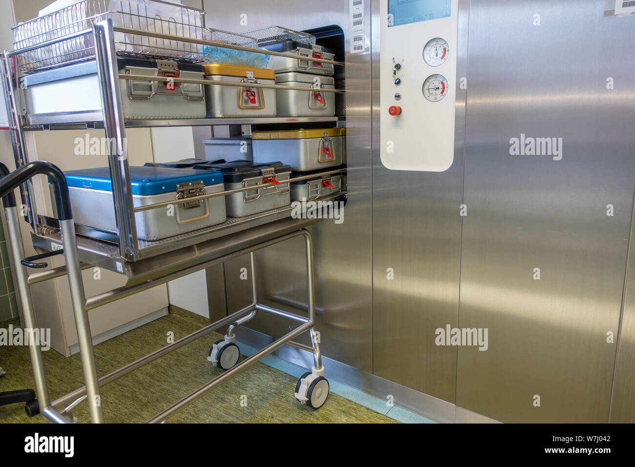 different instrument containers are pushed into a sterilization unit ...