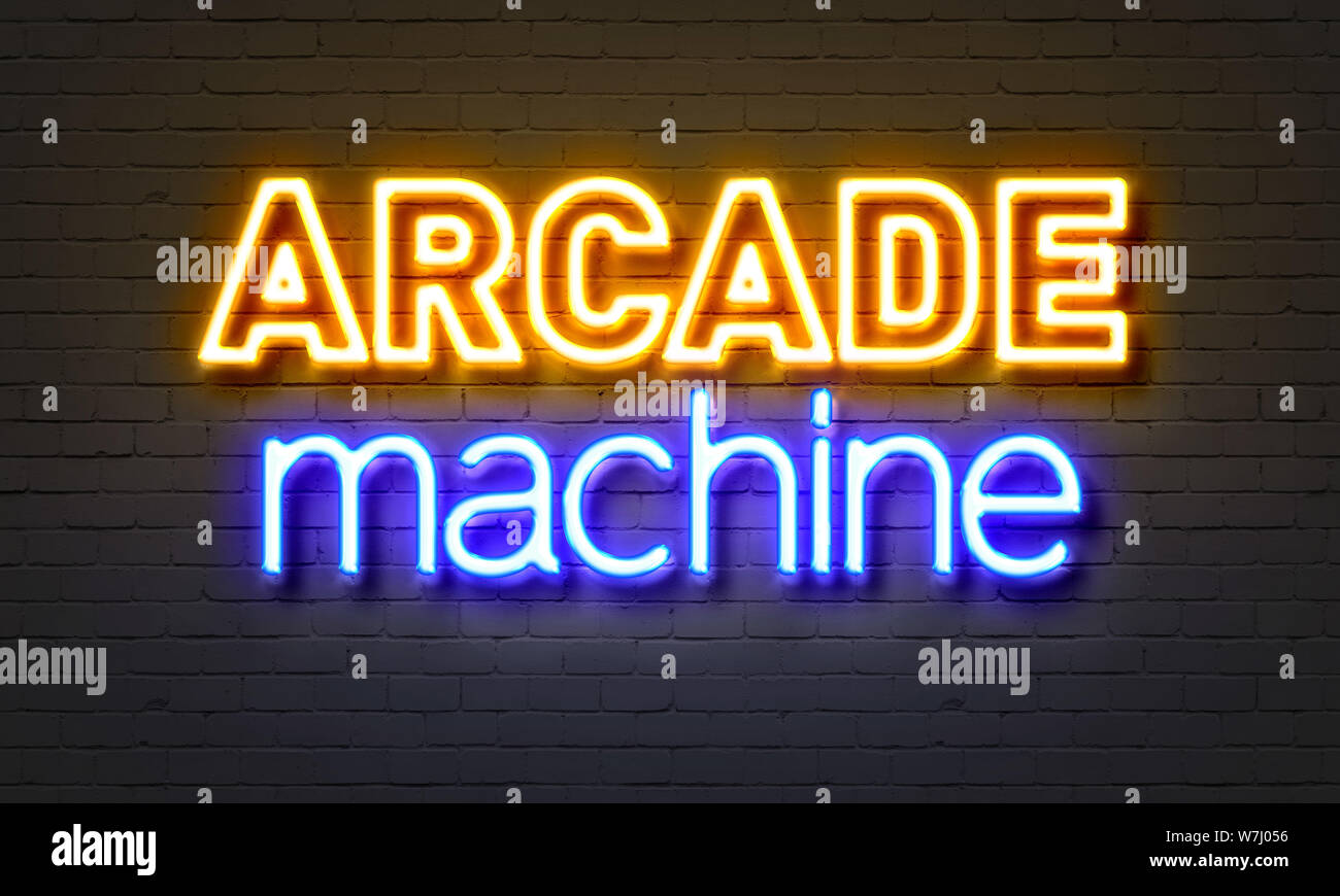 Arcade machine neon sign on brick wall background Stock Photo - Alamy