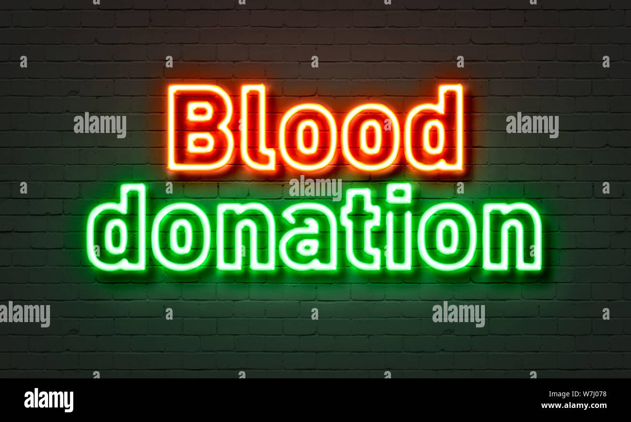 Blood donation neon sign on brick wall background Stock Photo - Alamy