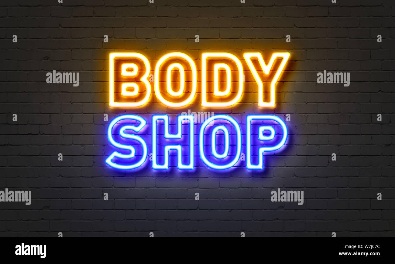 Body shop neon sign on brick wall background Stock Photo - Alamy