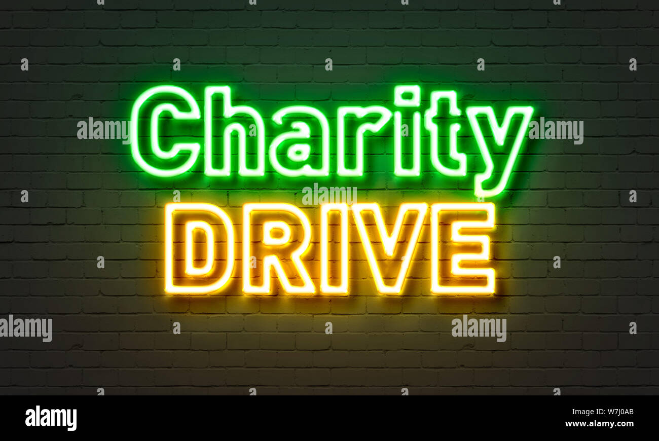 Charity drive neon sign on brick wall background Stock Photo - Alamy