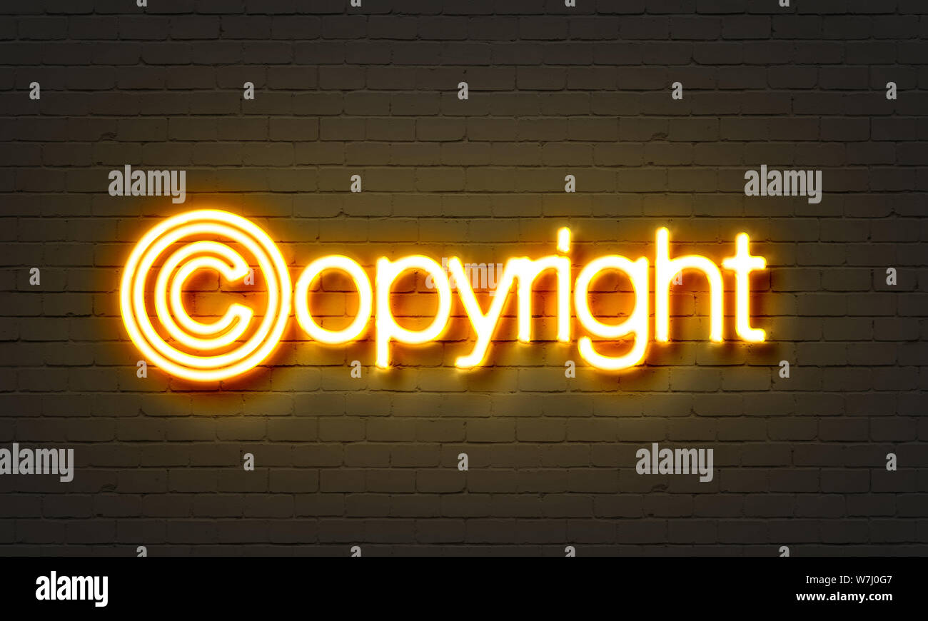 Copyright neon sign on brick wall background Stock Photo - Alamy