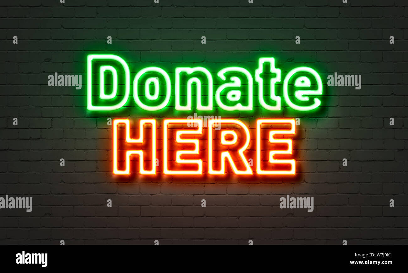 Donate here neon sign on brick wall background Stock Photo - Alamy