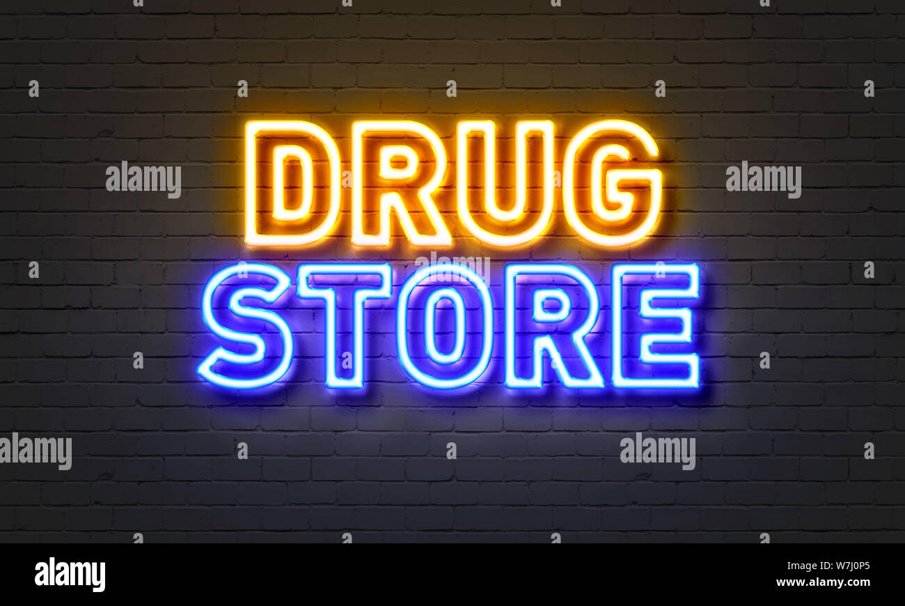 Drug store neon sign on brick wall background Stock Photo - Alamy