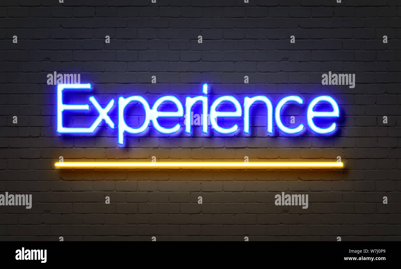 Experience neon sign on brick wall background Stock Photo - Alamy