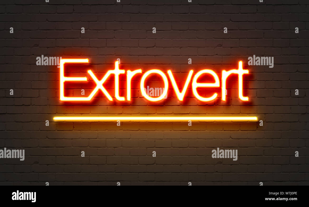 Extrovert neon sign on brick wall background Stock Photo - Alamy