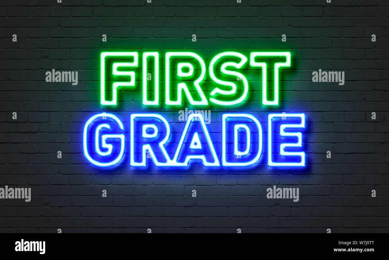 First grade neon sign on brick wall background Stock Photo - Alamy
