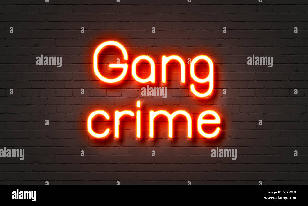 Gang crime neon sign on brick wall background Stock Photo - Alamy