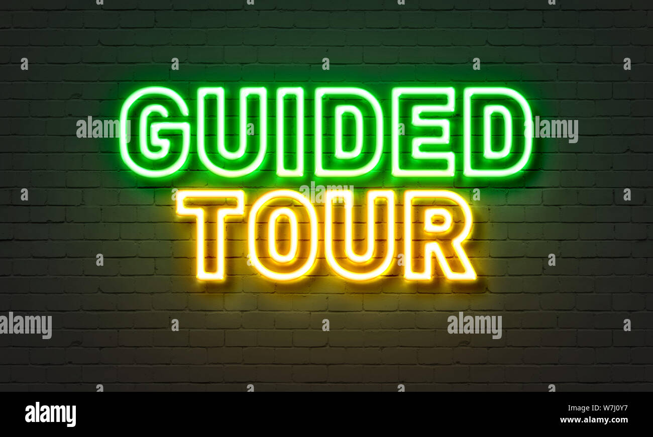Guided tour neon sign on brick wall background Stock Photo - Alamy