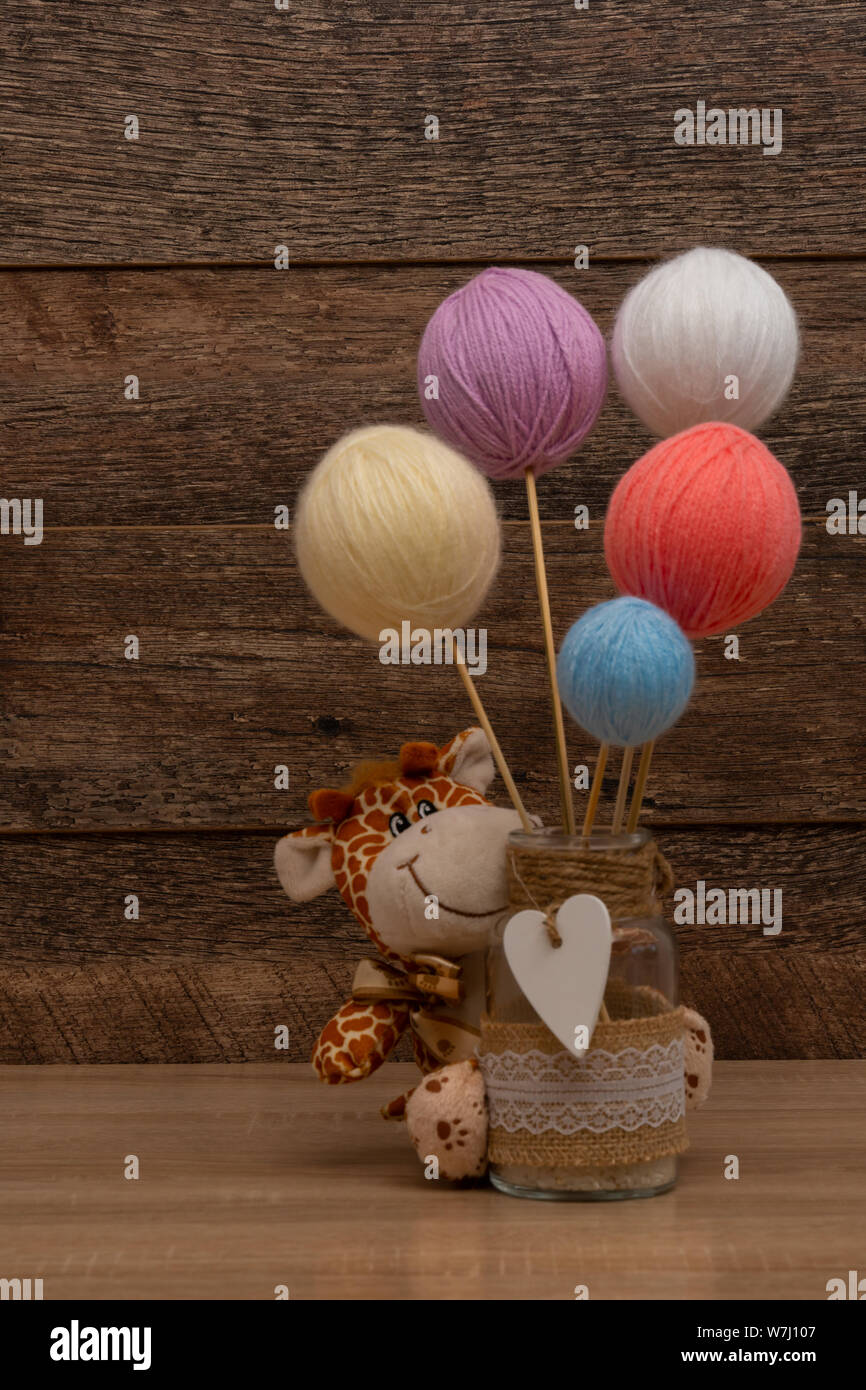 Colored yarn balls with plush toy, top view Stock Photo - Alamy