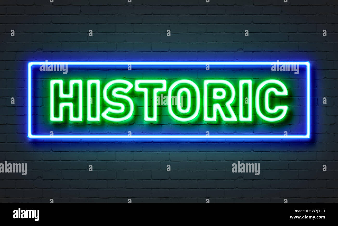 Historic neon sign on brick wall background Stock Photo - Alamy