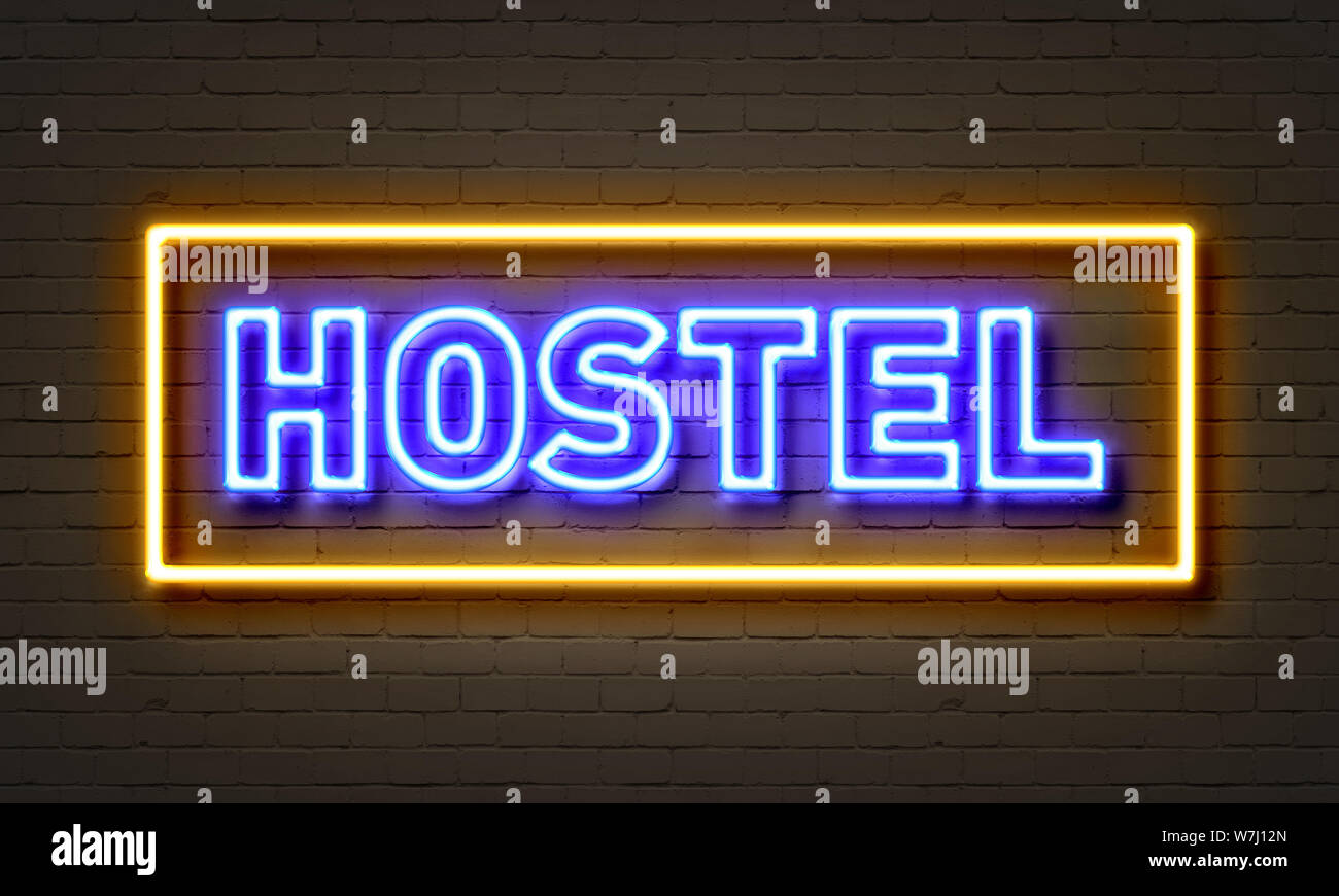 Hostel neon sign on brick wall background Stock Photo - Alamy