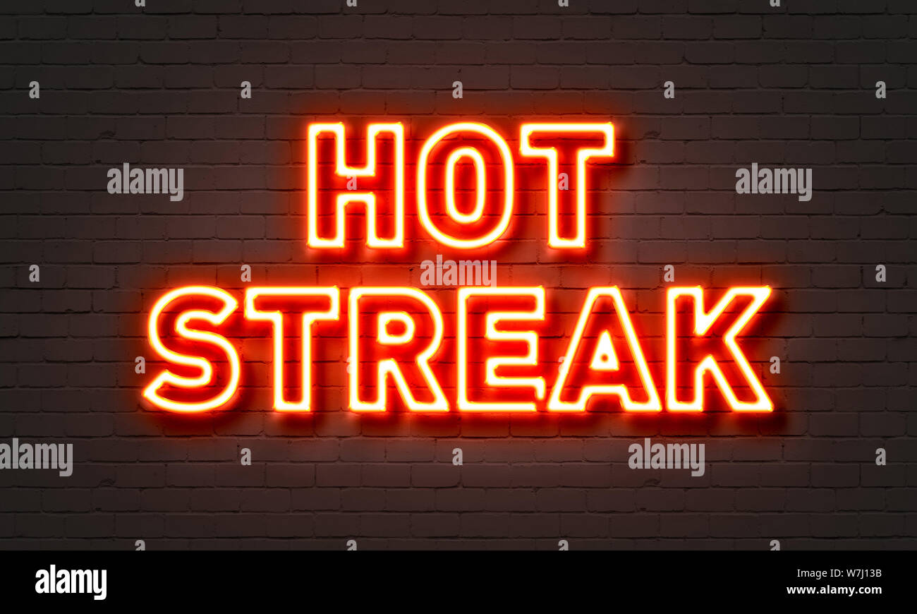 Hot streak neon sign on brick wall background Stock Photo - Alamy