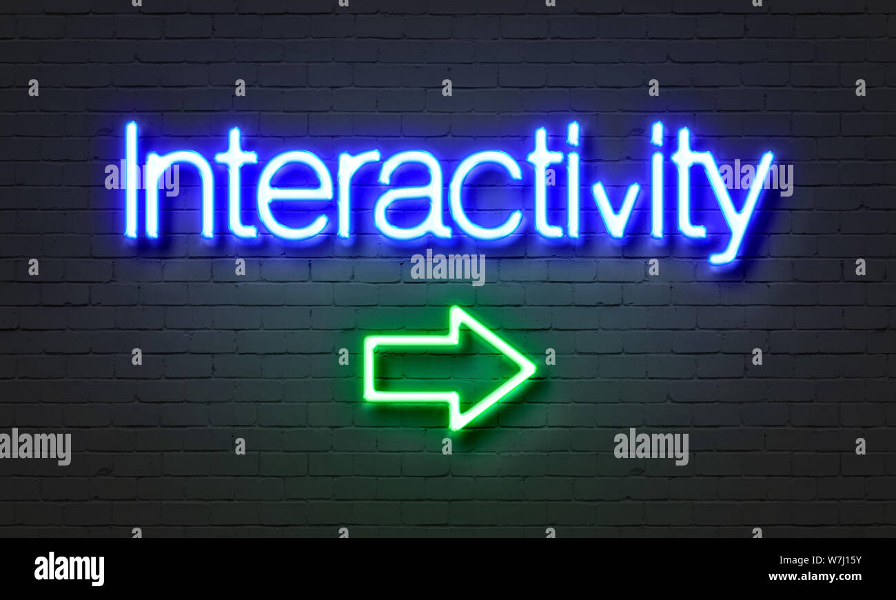 Interactivity neon sign on brick wall background Stock Photo - Alamy