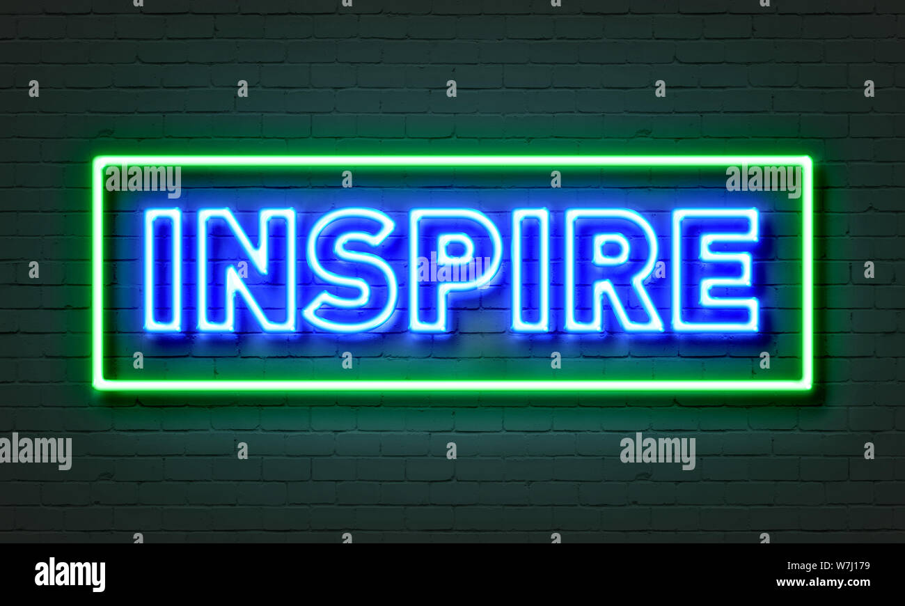 Inspire neon sign on brick wall background Stock Photo - Alamy