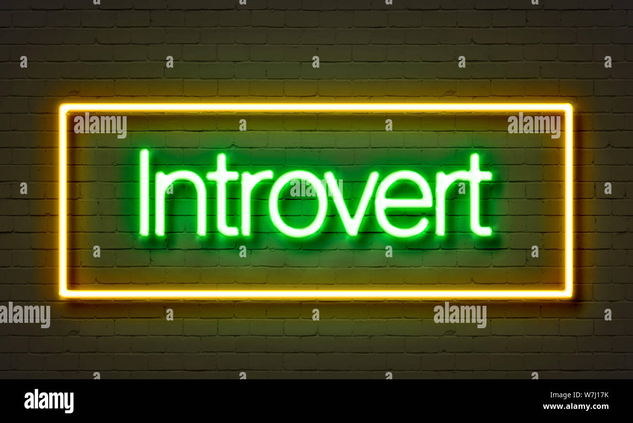 Introvert neon sign on brick wall background Stock Photo - Alamy