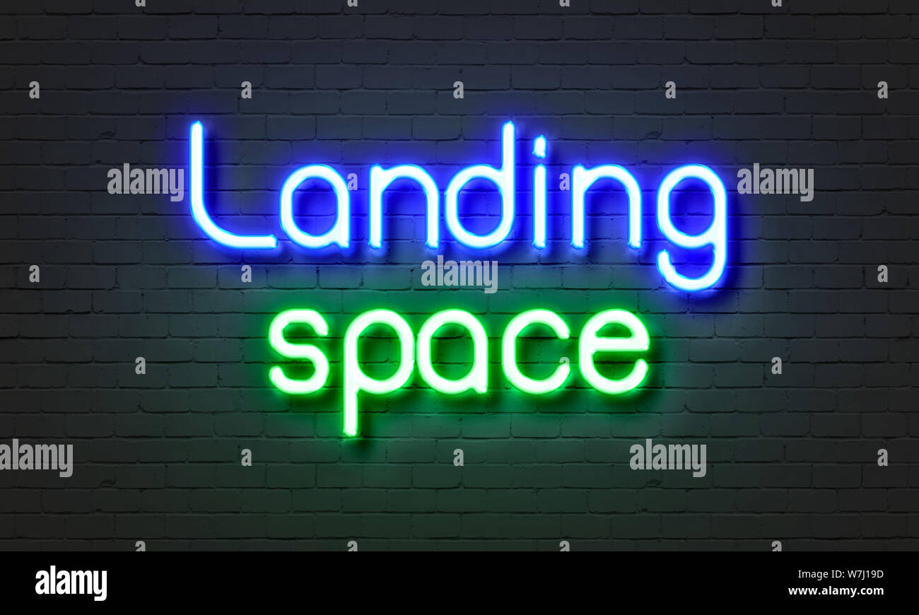 Landing space neon sign on brick wall background Stock Photo - Alamy