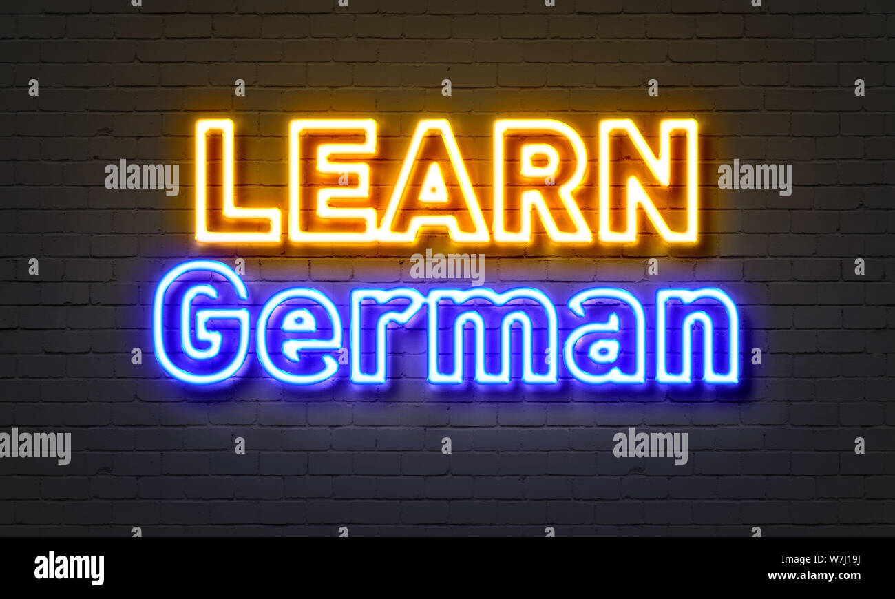 Learn German neon sign on brick wall background Stock Photo - Alamy