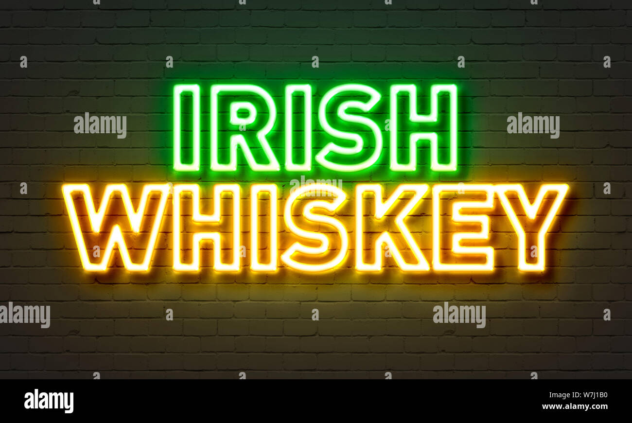 Irish whiskey neon sign on brick wall background Stock Photo - Alamy