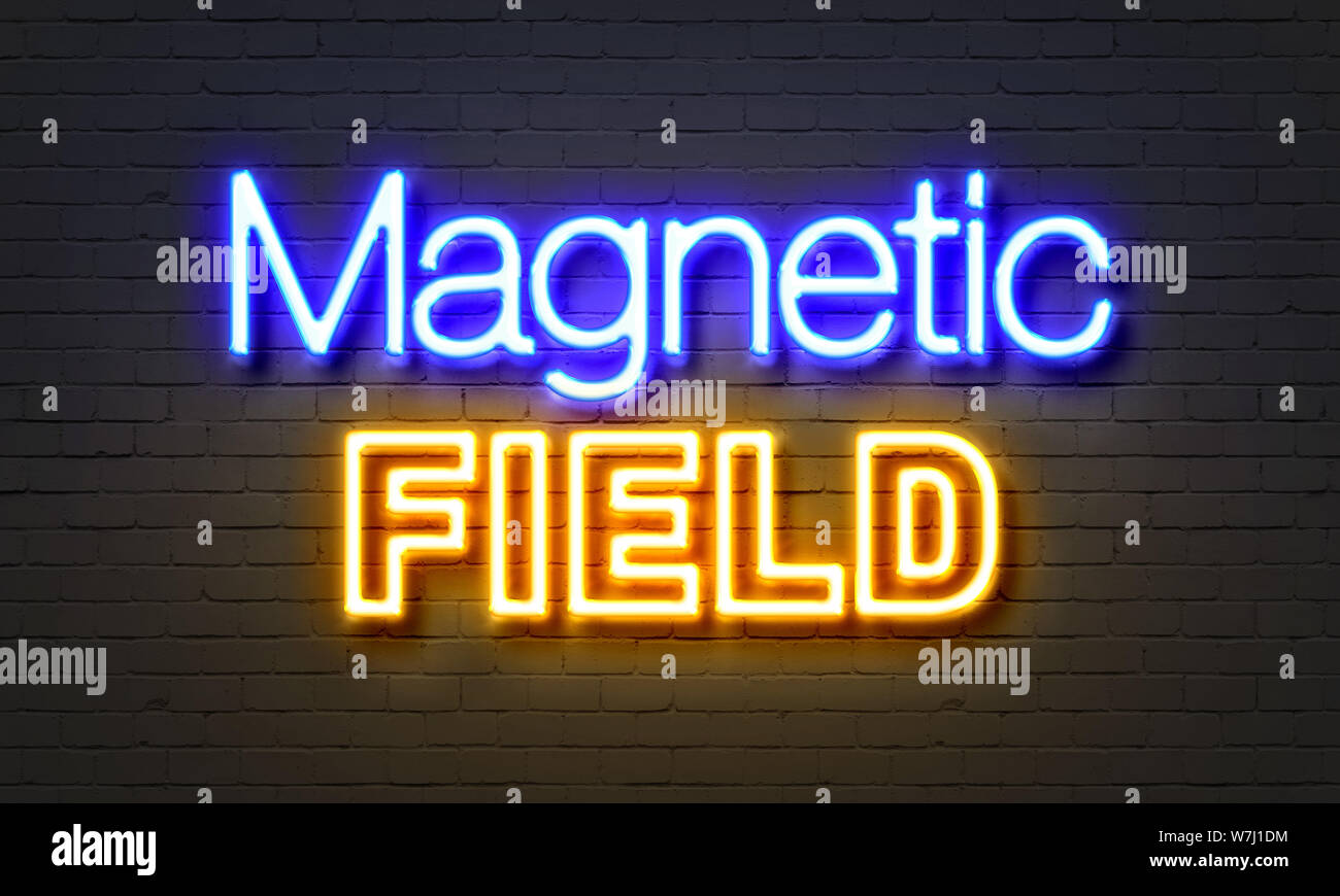 Magnetic field neon sign on brick wall background Stock Photo - Alamy