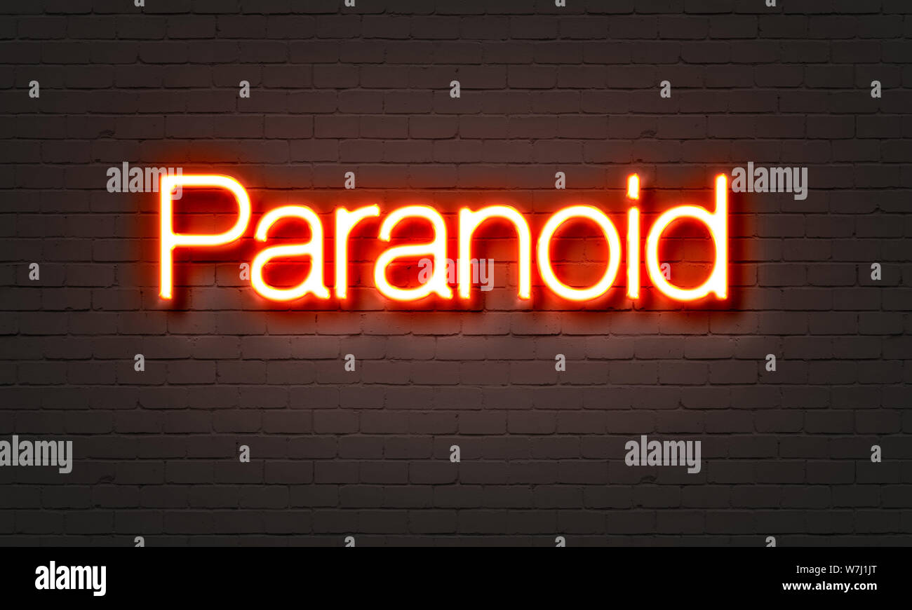 Paranoid neon sign on brick wall background Stock Photo - Alamy