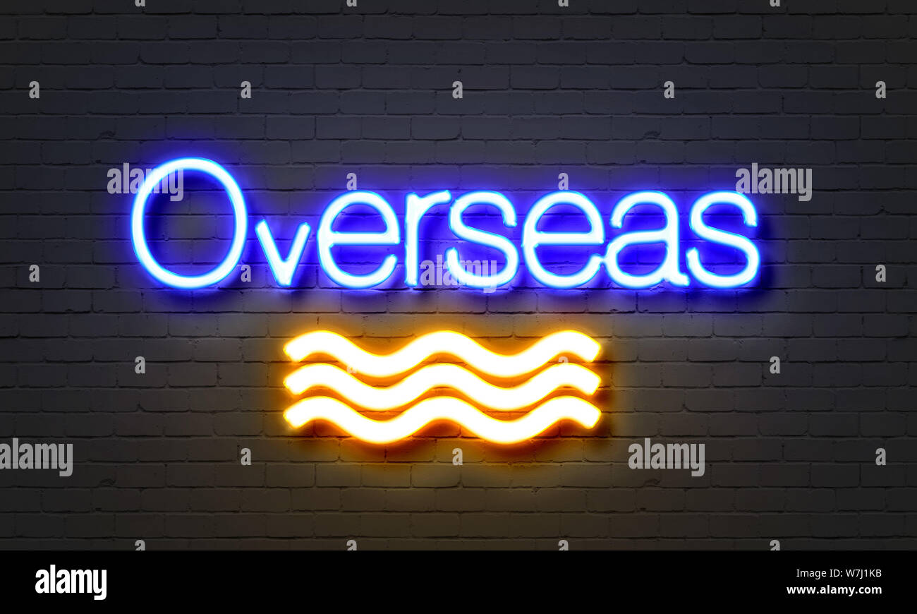 Overseas neon sign on brick wall background Stock Photo - Alamy