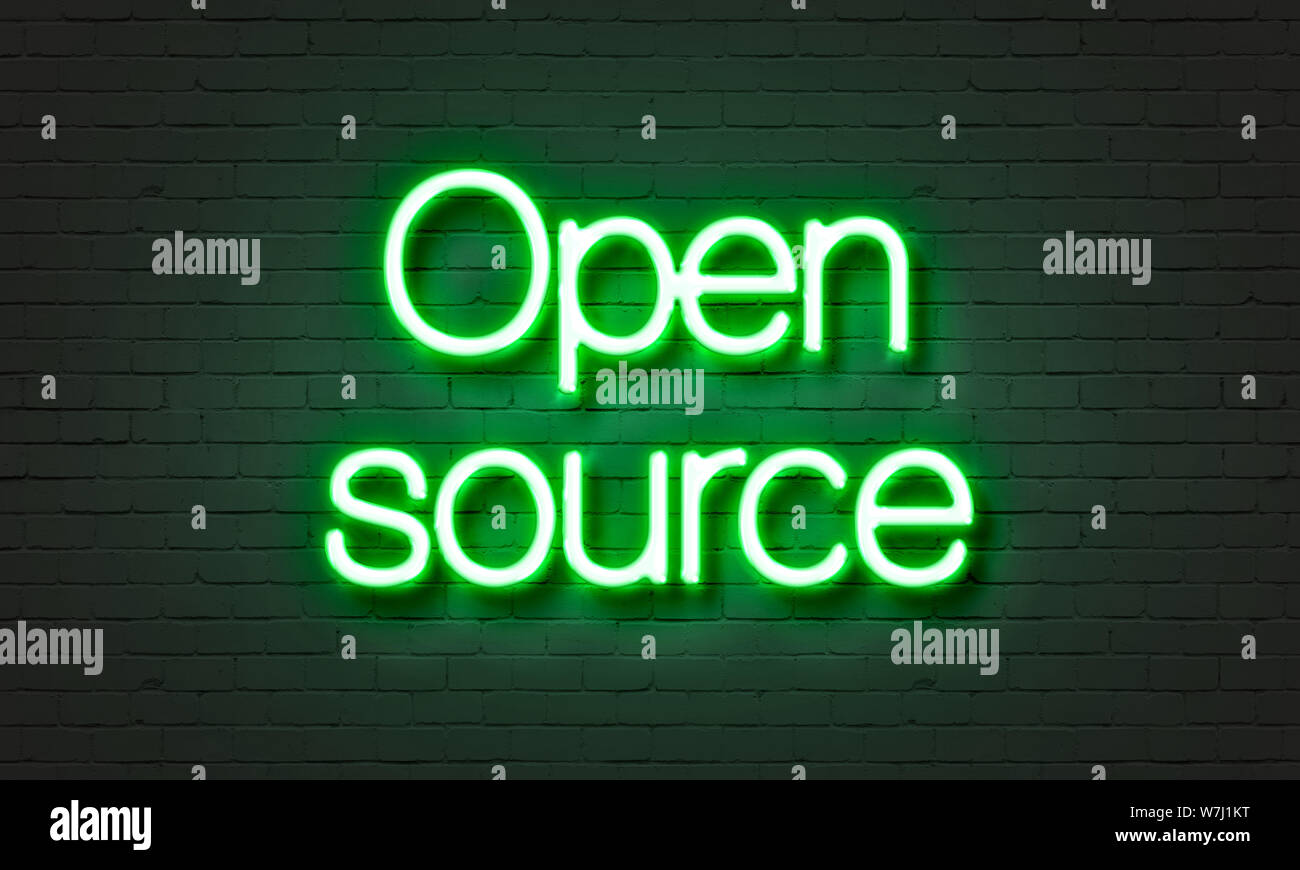 Open source neon sign on brick wall background Stock Photo - Alamy