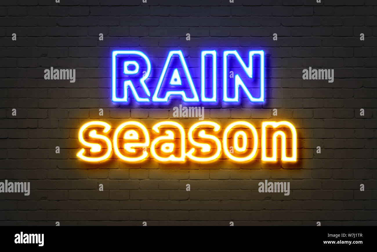 Rain season neon sign on brick wall background Stock Photo - Alamy