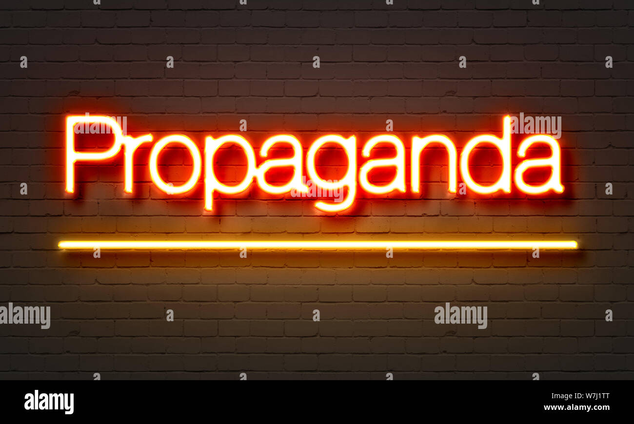 Propaganda neon sign on brick wall background Stock Photo - Alamy