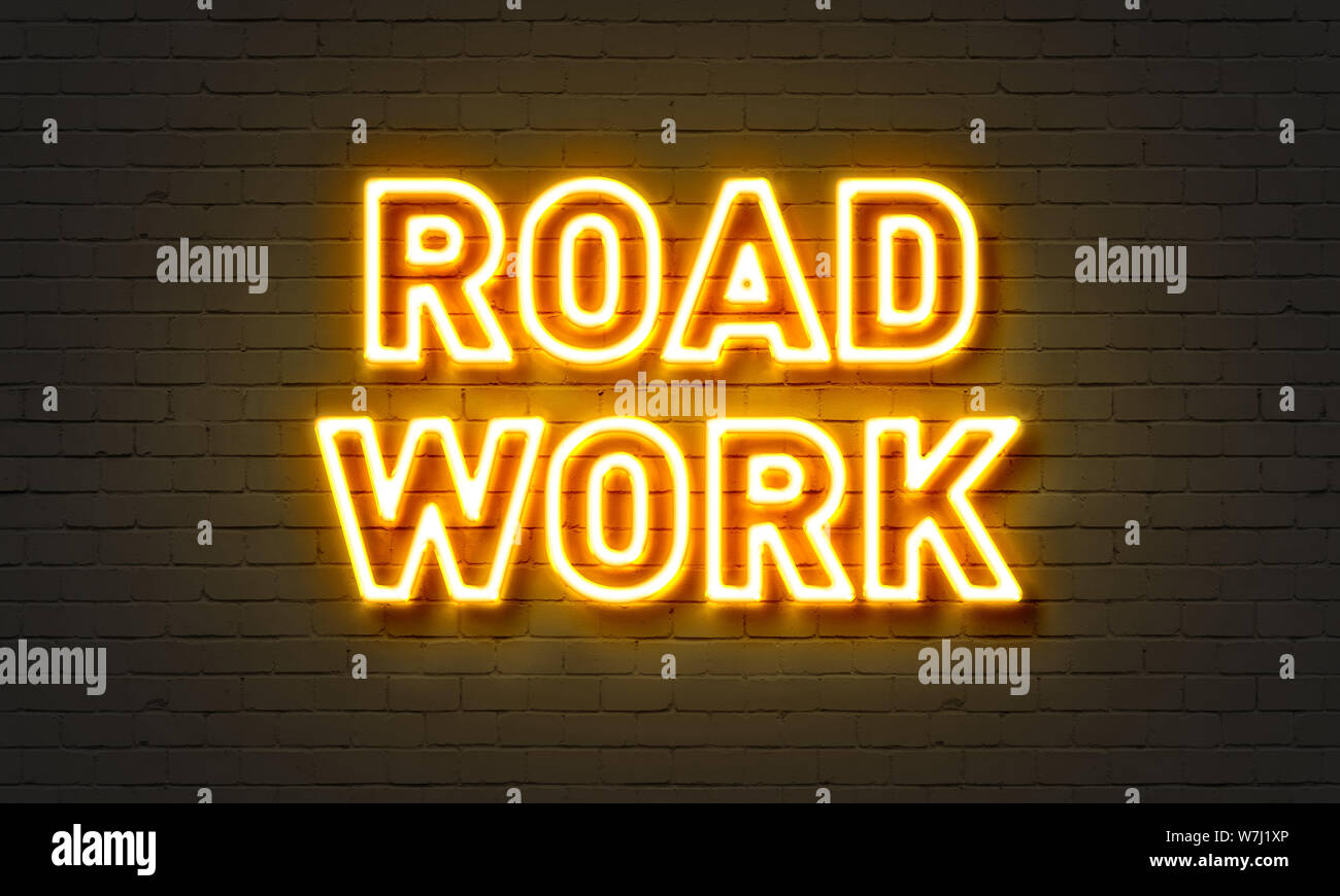 Road work neon sign on brick wall background Stock Photo - Alamy